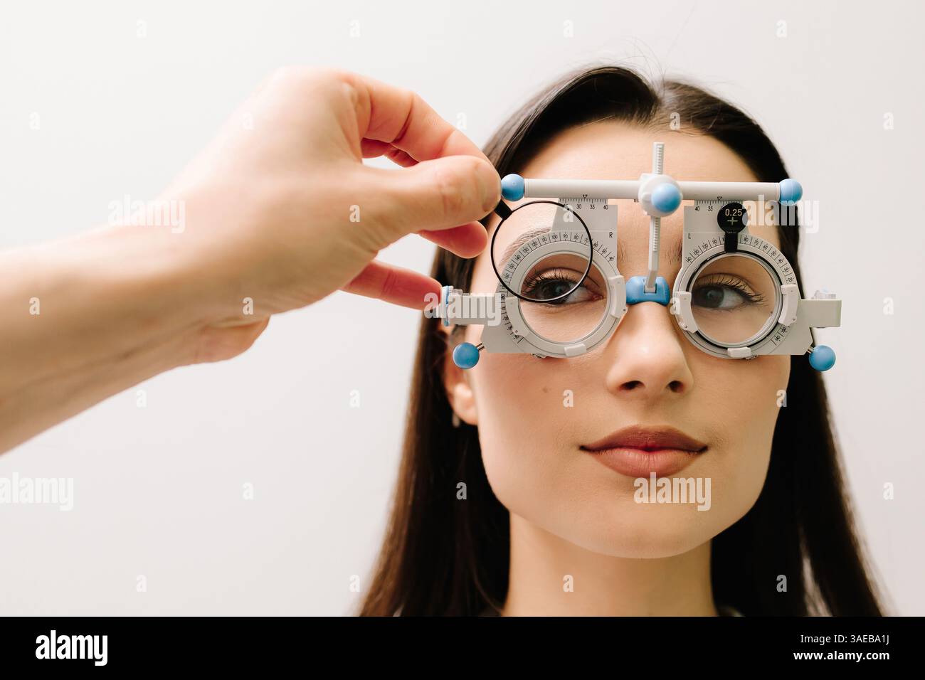 Girl is wearing trial frame glasses for eye exam vision test by ...