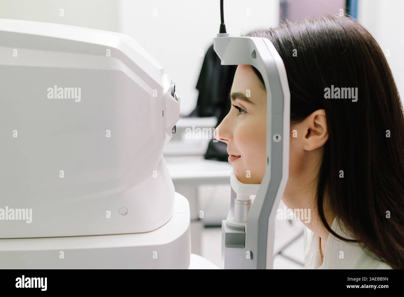 Examination of eyes of patient using optical coherence tomograph. Ophthalmologist is scanning ...