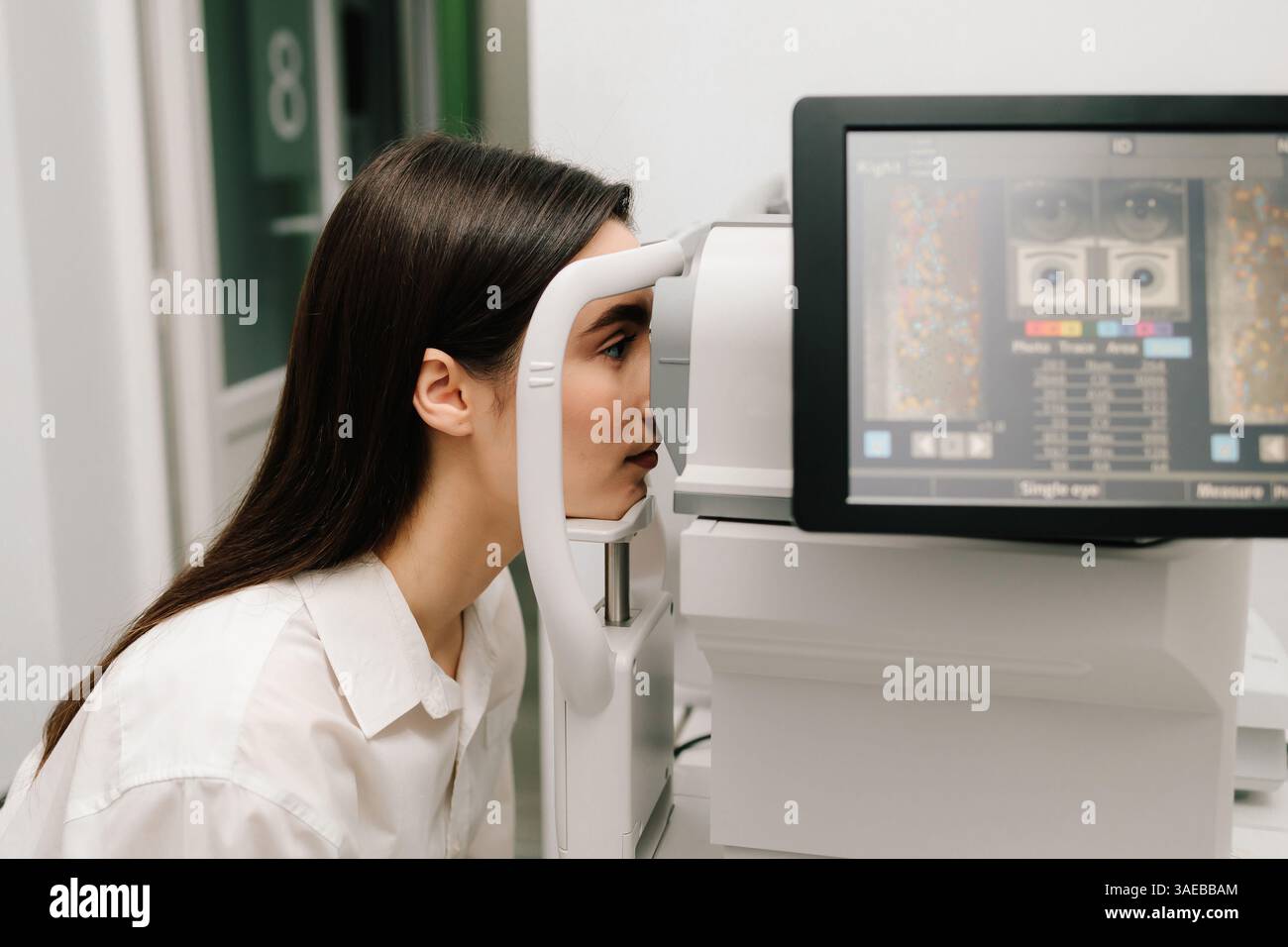 Girl undergoes an OCT eye exam using advanced optical coherence ...