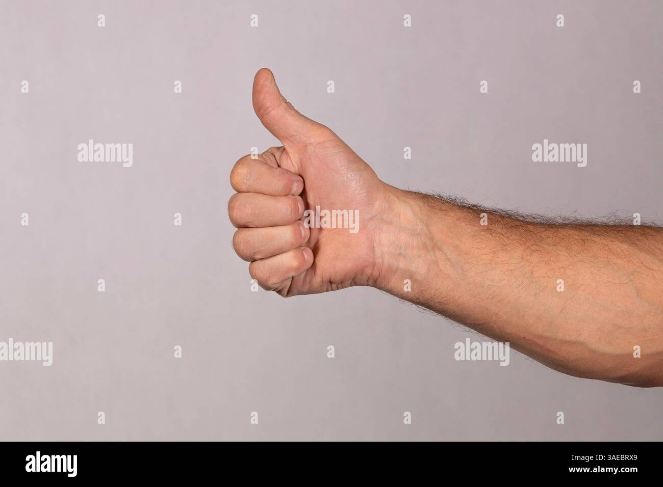 hairy caucasian male hand with thumbs up in an ok sign palm facing ...