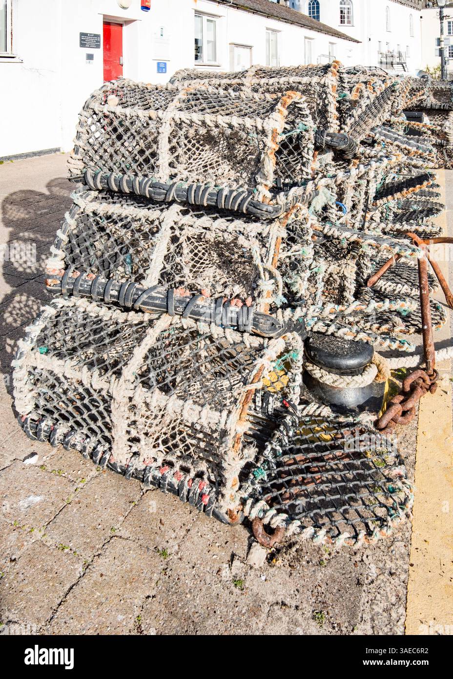 Vintage lobster pots stacked on the harbour side at Tenby in ...