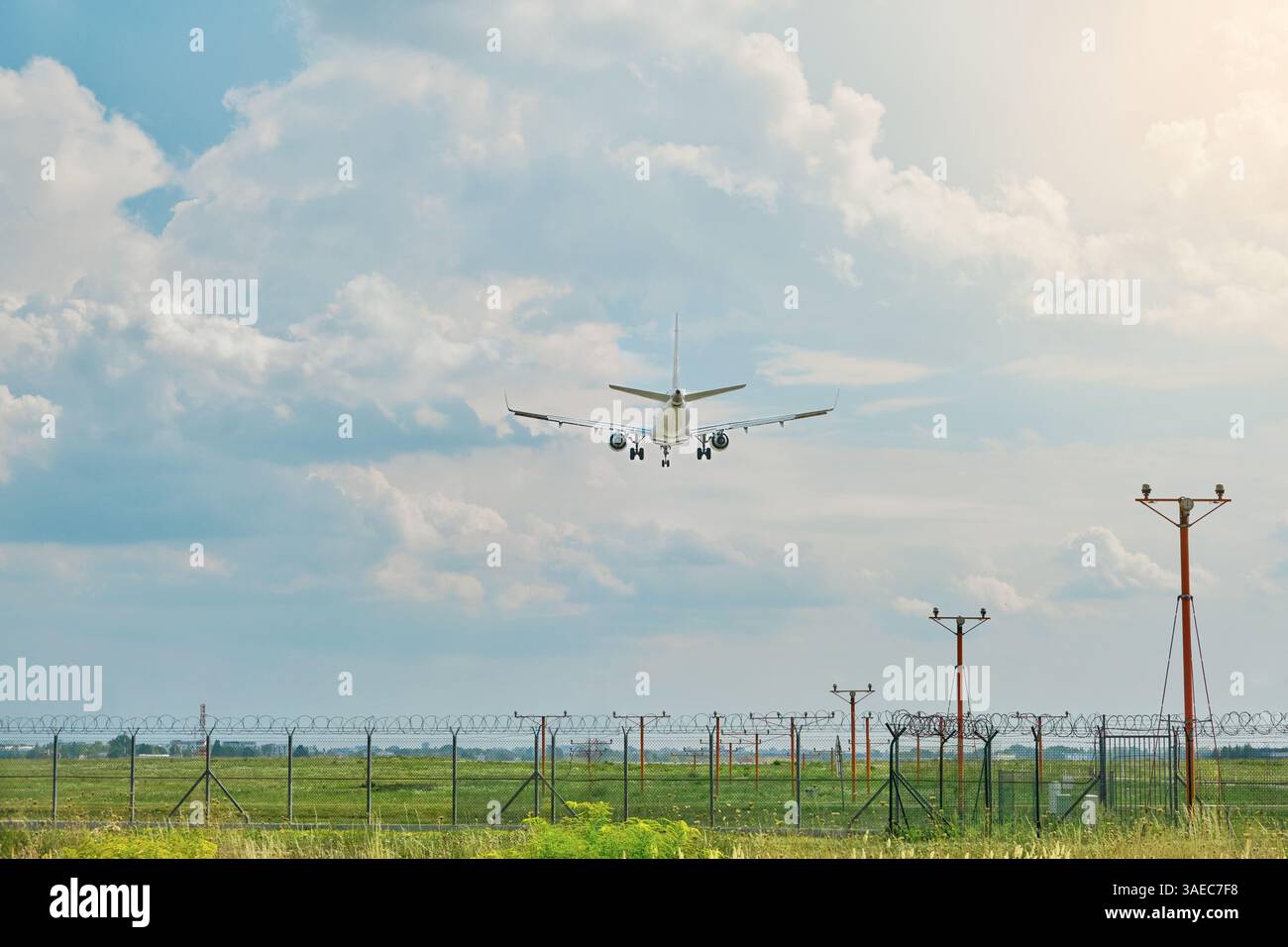 Passenger airplane landing on airport runway during on sunny day ...