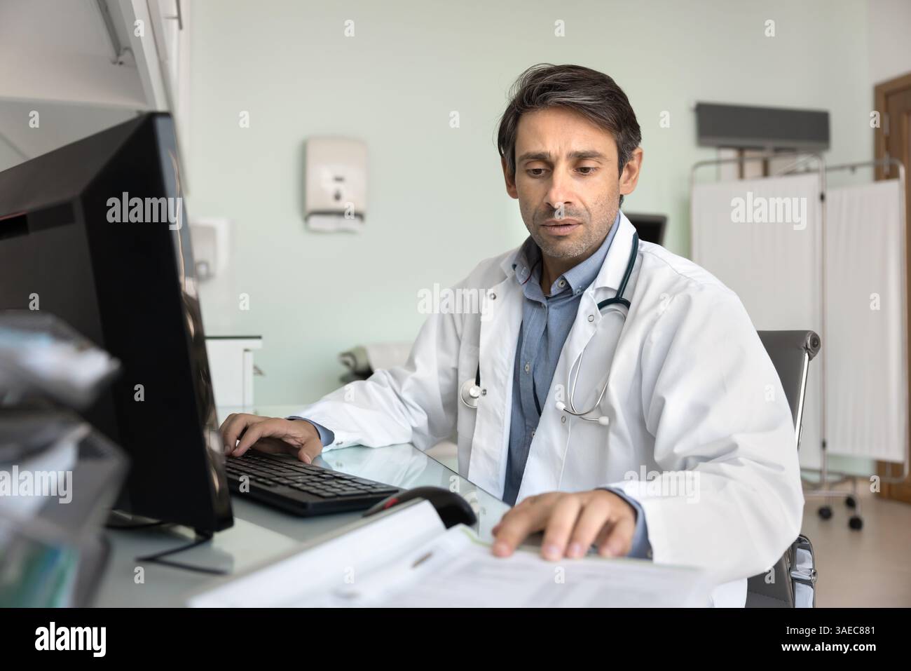 Reviewing documents male doctor hi-res stock photography and images - Alamy