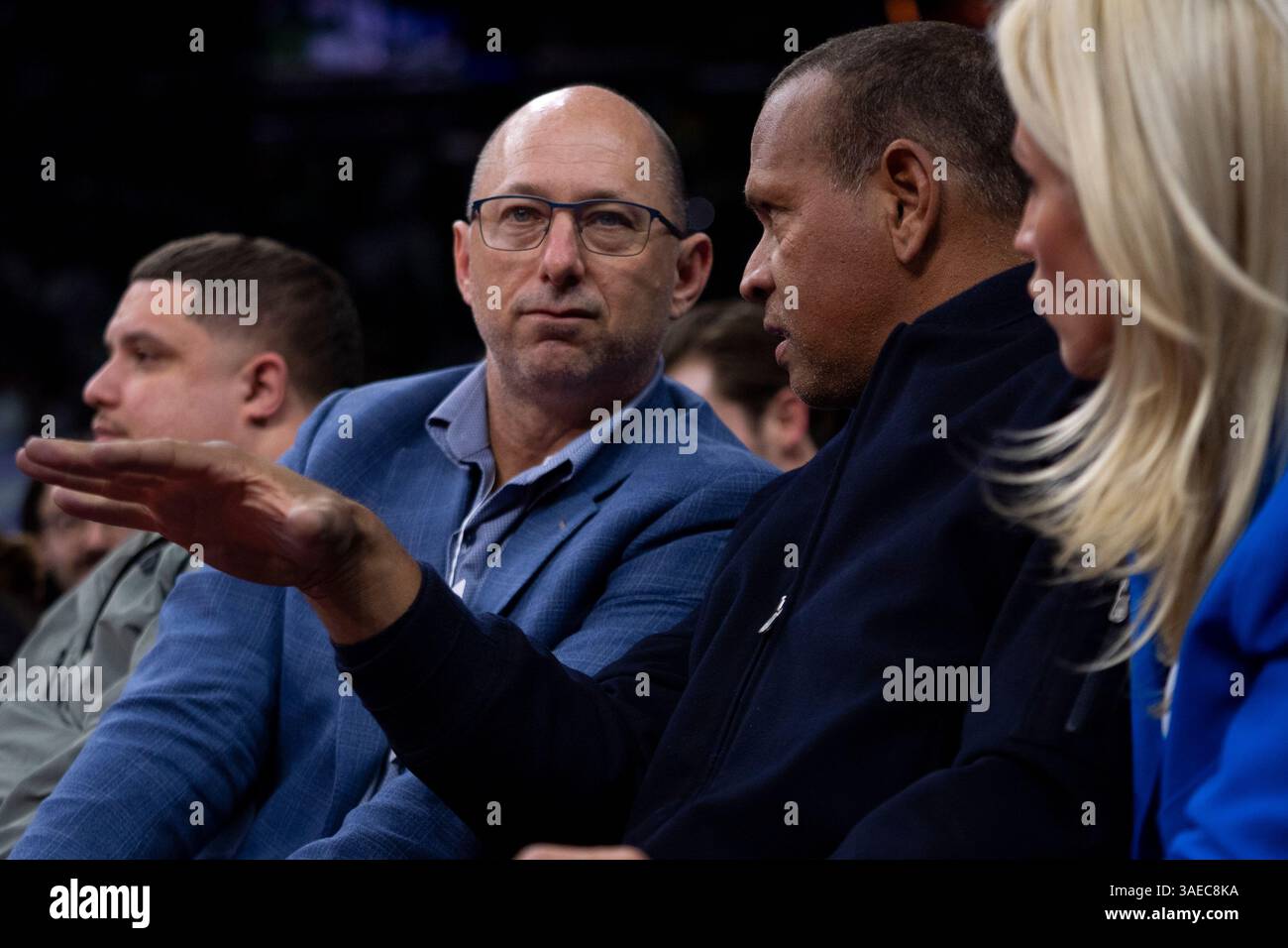 Alex Rodriguez, center, talks things over with Marc Lore, left, looks ...
