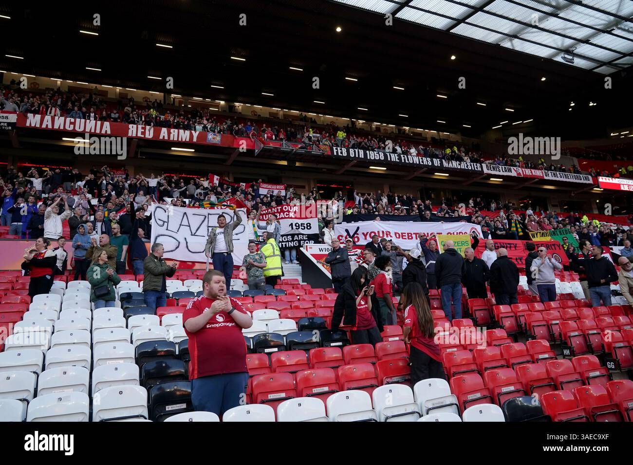 Manchester United fans hold up banners in protects after the Premier ...