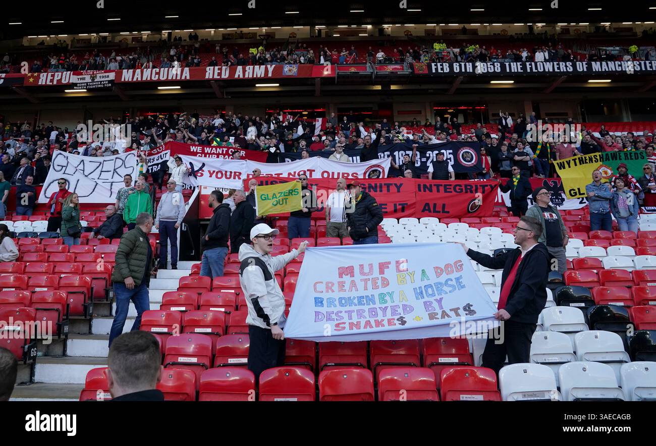 Manchester United fans hold up banners in protects after the Premier ...