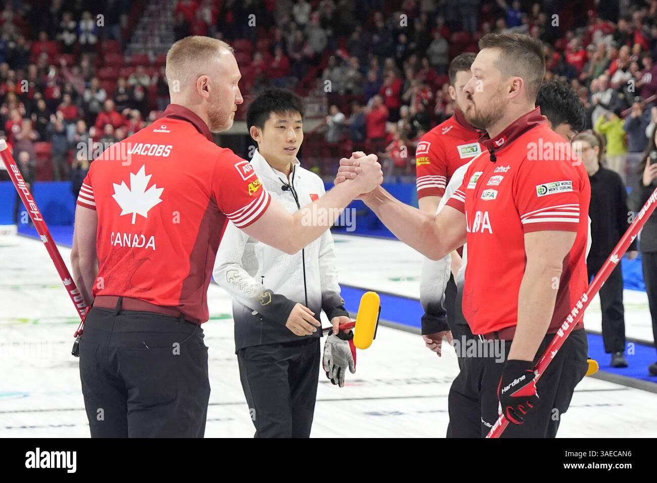 Canada's skip Brad Jacobs congratulates Ben Hebert after their country ...