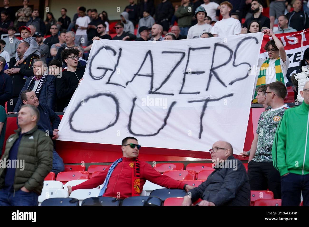 Manchester United fans hold up banners during a sit-in protest against ...
