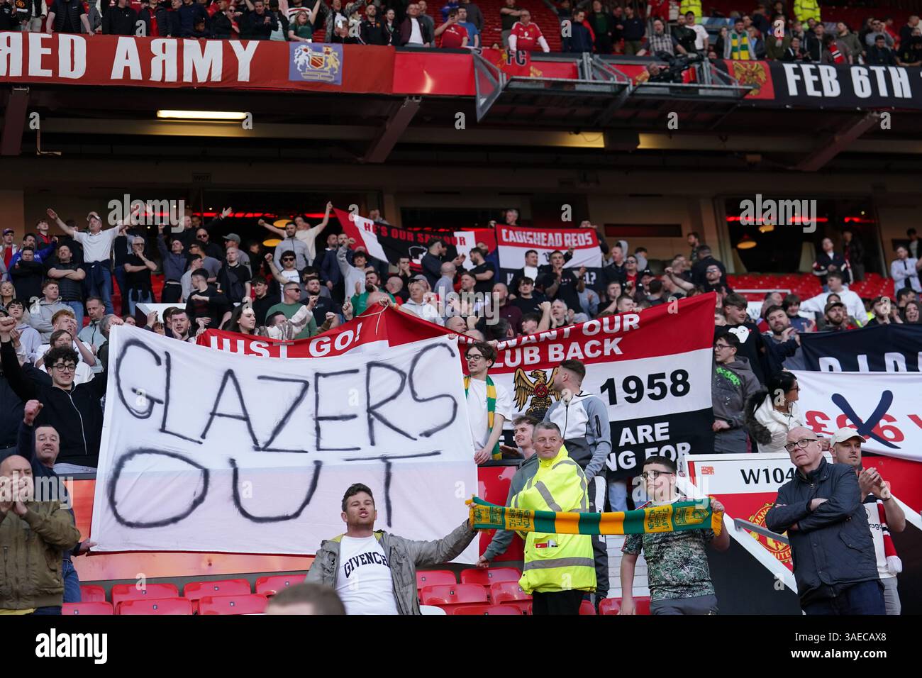 Manchester United fans hold up banners during a sit-in protest against ...