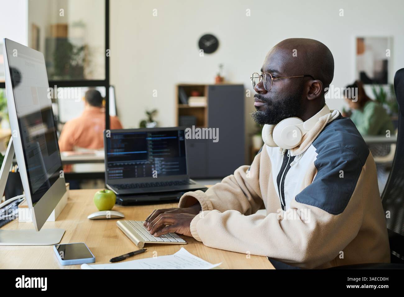 Young serious man concentrating on work over new content while looking ...