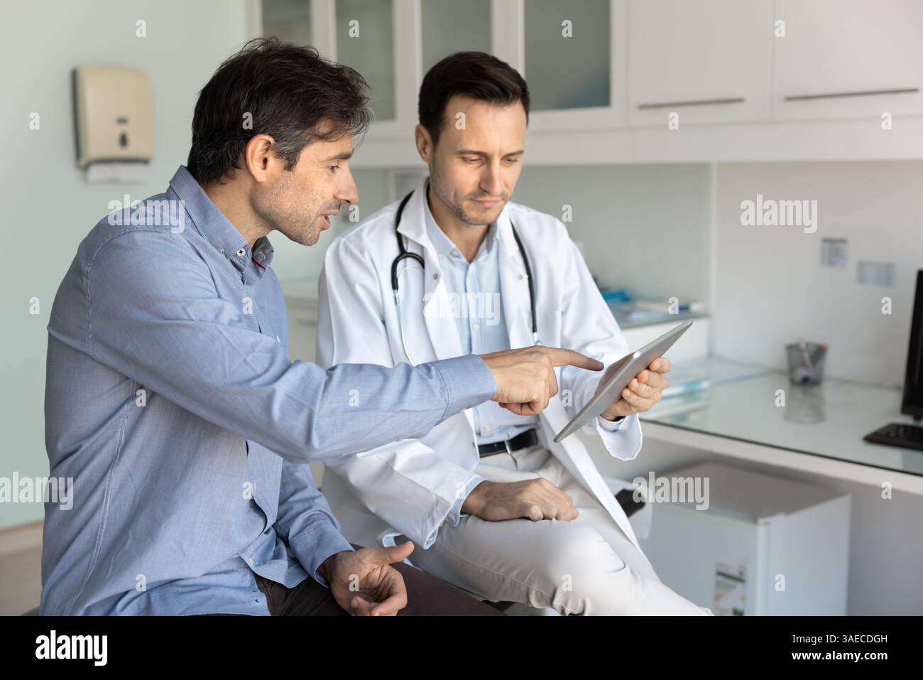 Cardiologist consulting man patient during his visit in clinic Stock ...