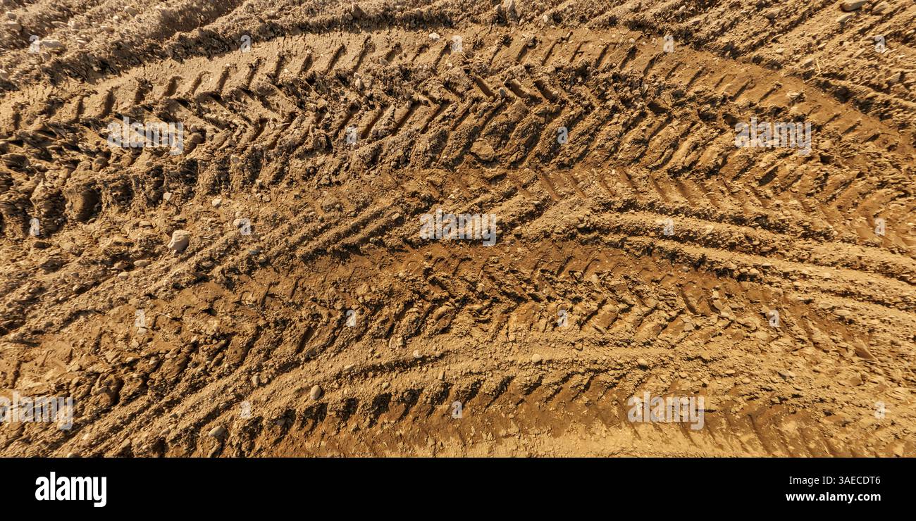 view from above on texture of dry road with tractor tire tracks in ...