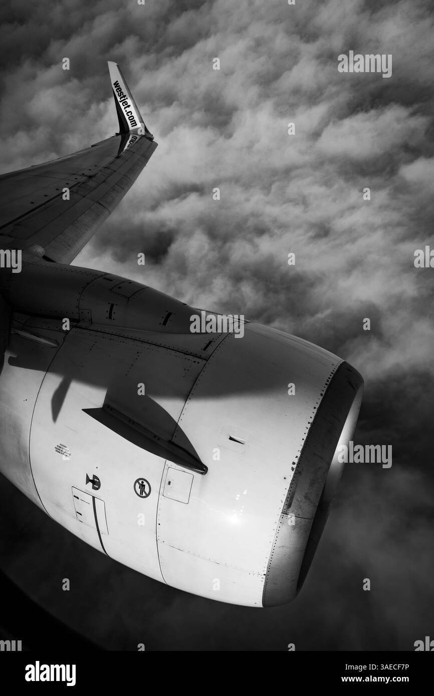 Airplane wing and engine flying over a cloudy background Stock Photo ...