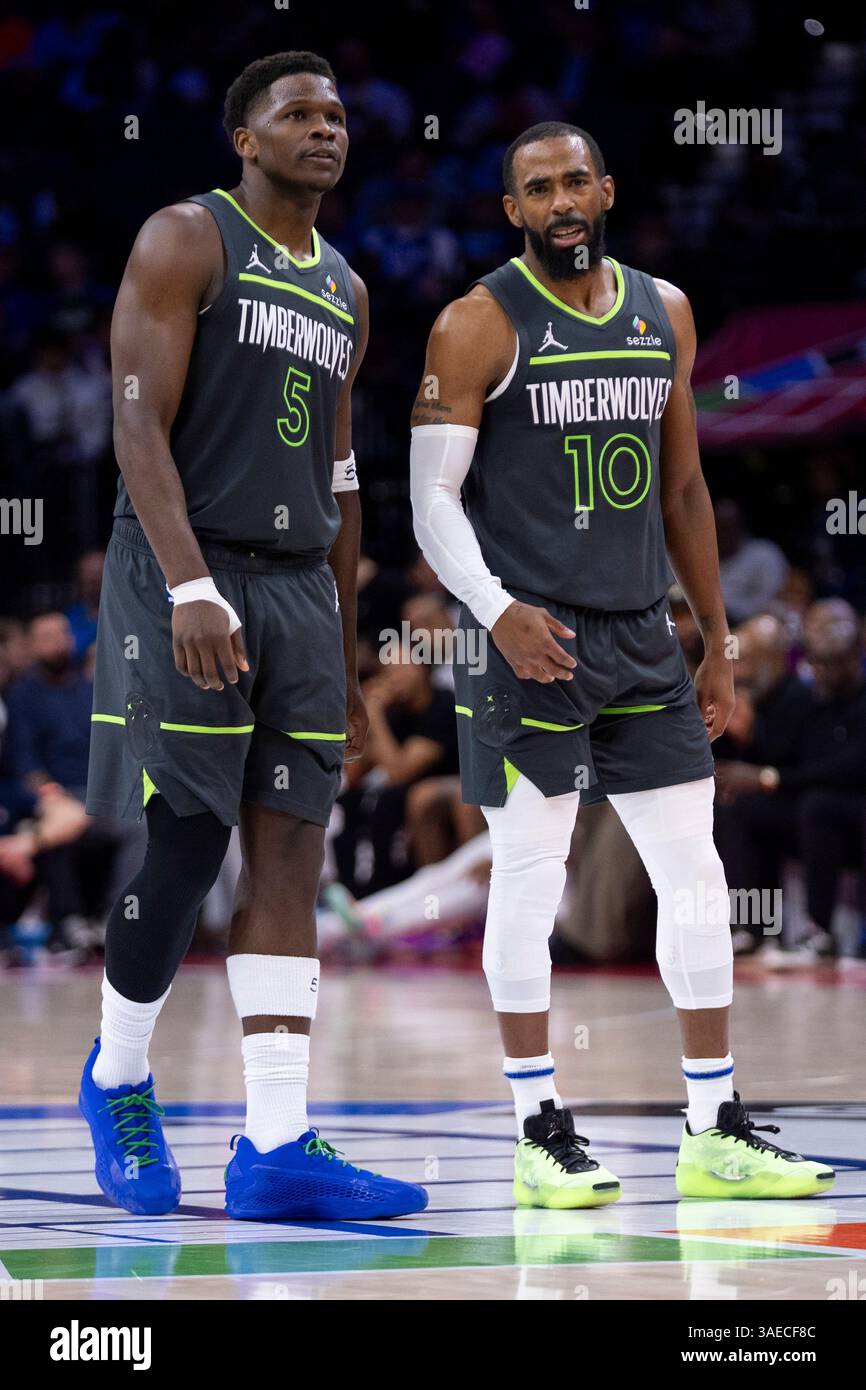 Minnesota Timberwolves' Mike Conley, right, talks with Anthony Edwards ...
