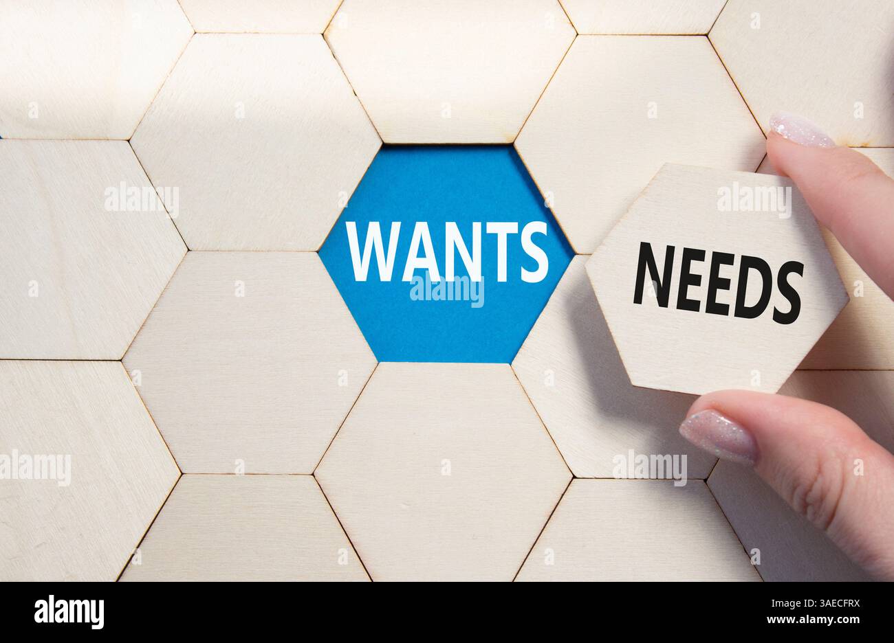 Wants and Needs symbol. Concept word Wants and Needs on wooden comb ...