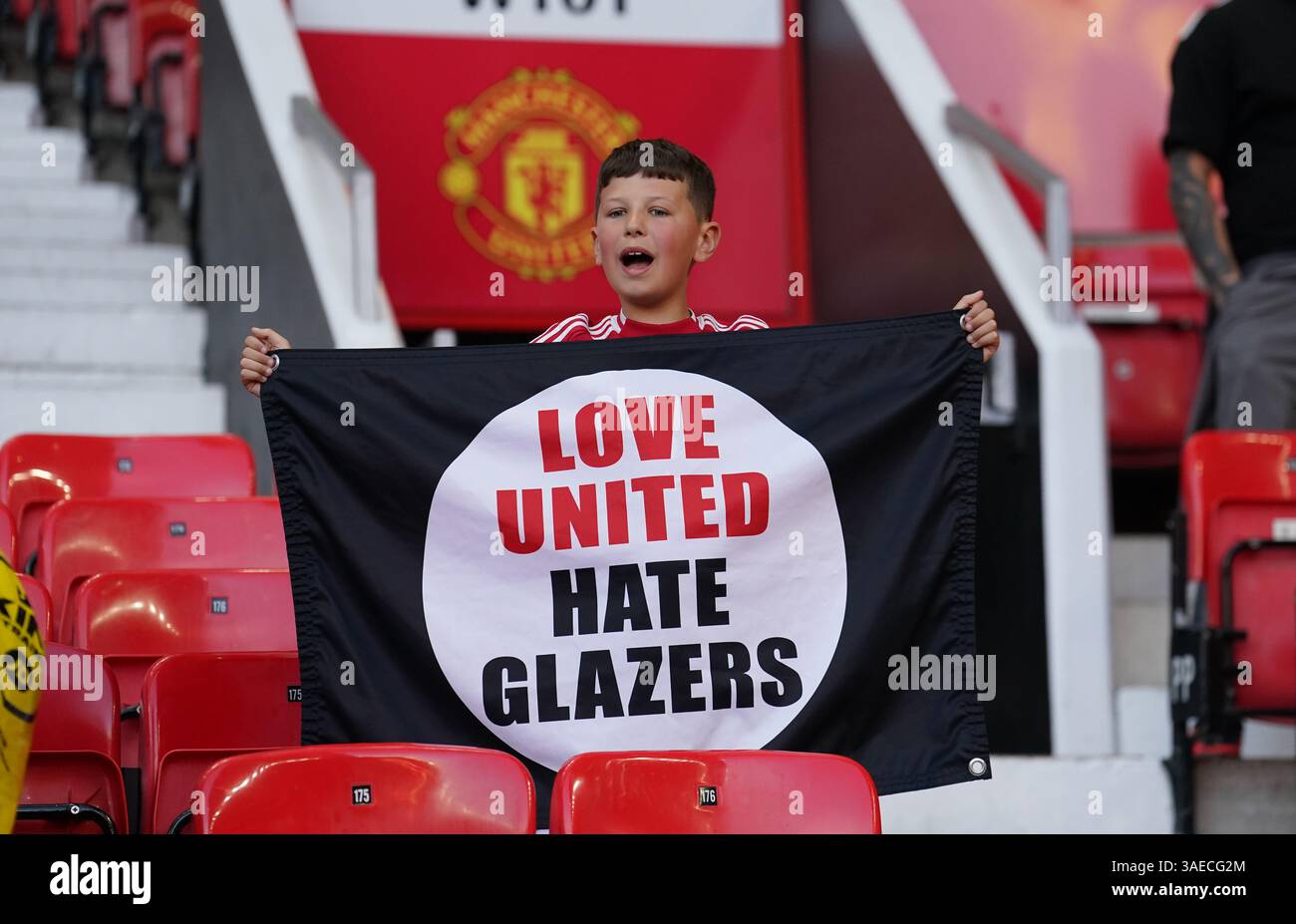 Manchester United fan hold up banners in protest after the Premier ...