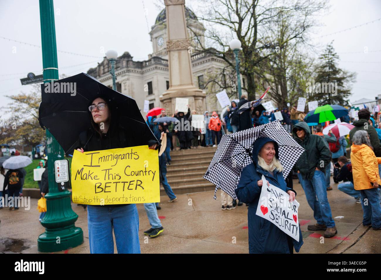 A protester holds a placard reading, “Immigrants make this country ...