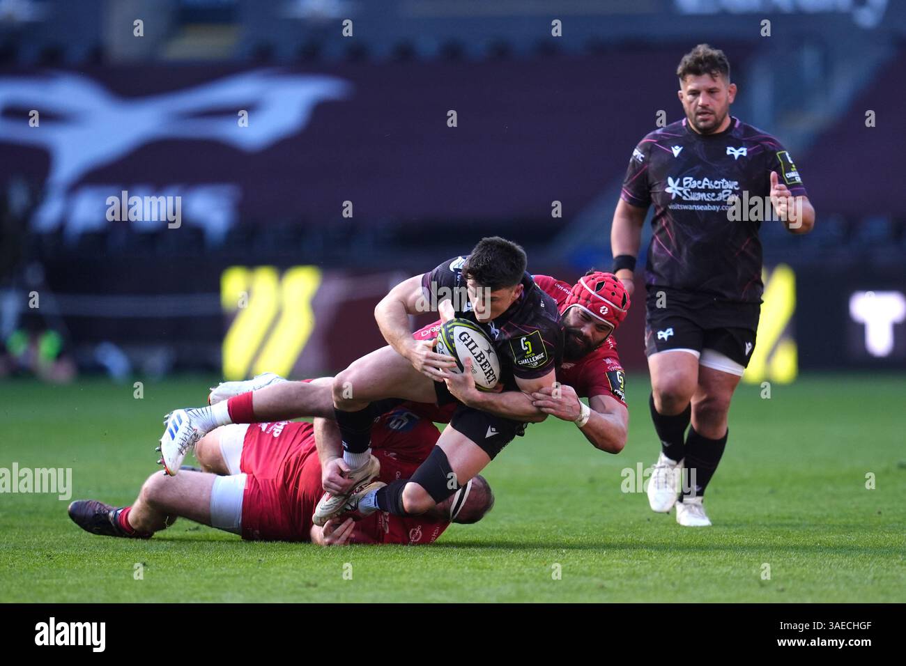 Ospreys' Reuben Morgan-Williams is tackled by Scarlets' Josh Macleod during the EPCR Challenge ...