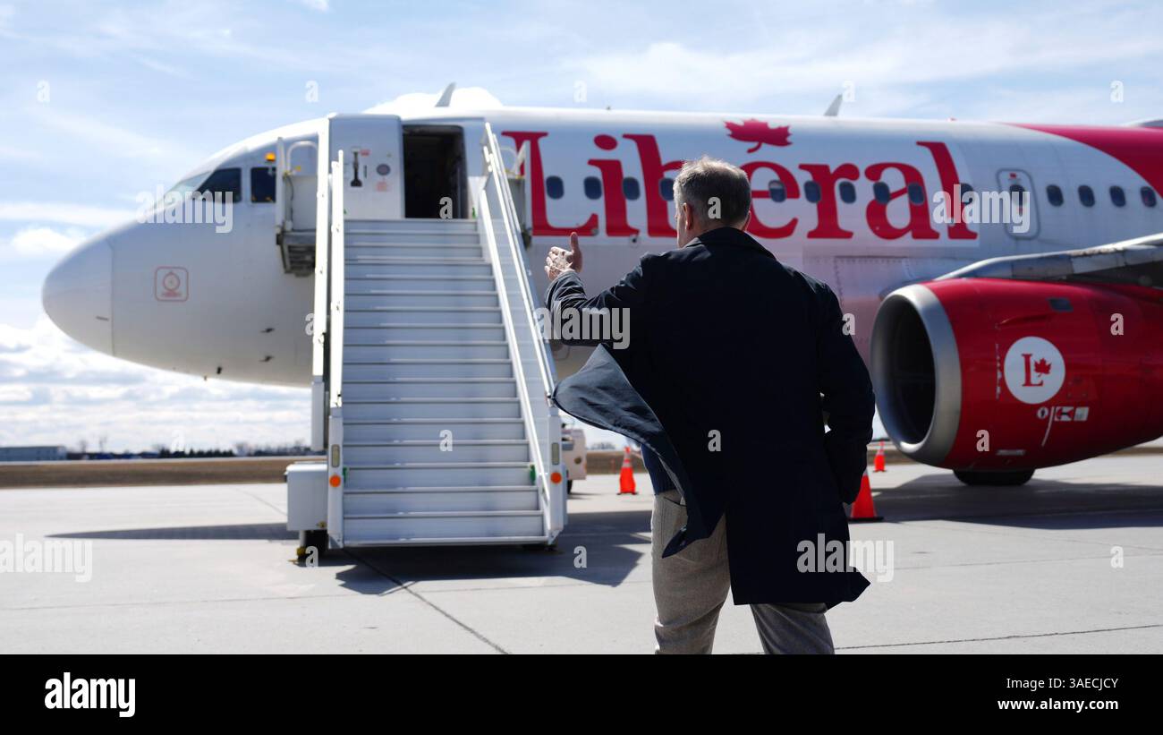 Canada Liberal leader Mark Carney boards his campaign plane in Ottawa ...