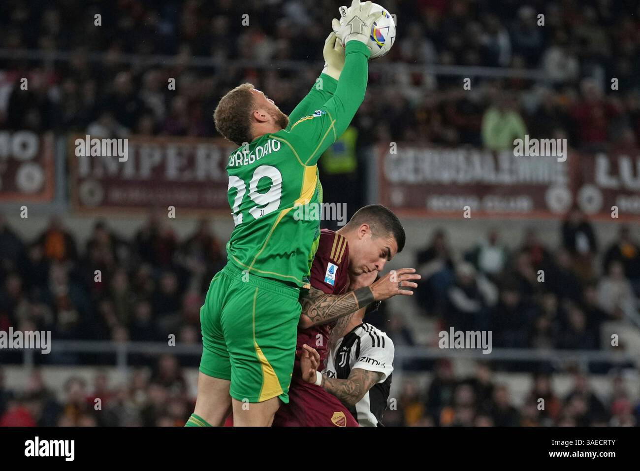 Juventus' goalkeeper Michele Di Gregorio gets the ball over Roma's ...