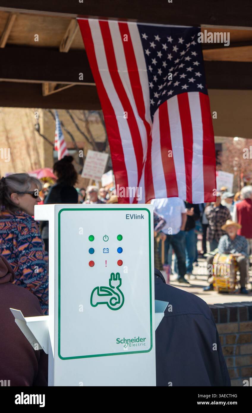 American flag and electric car charging station at a "Hands Off ...
