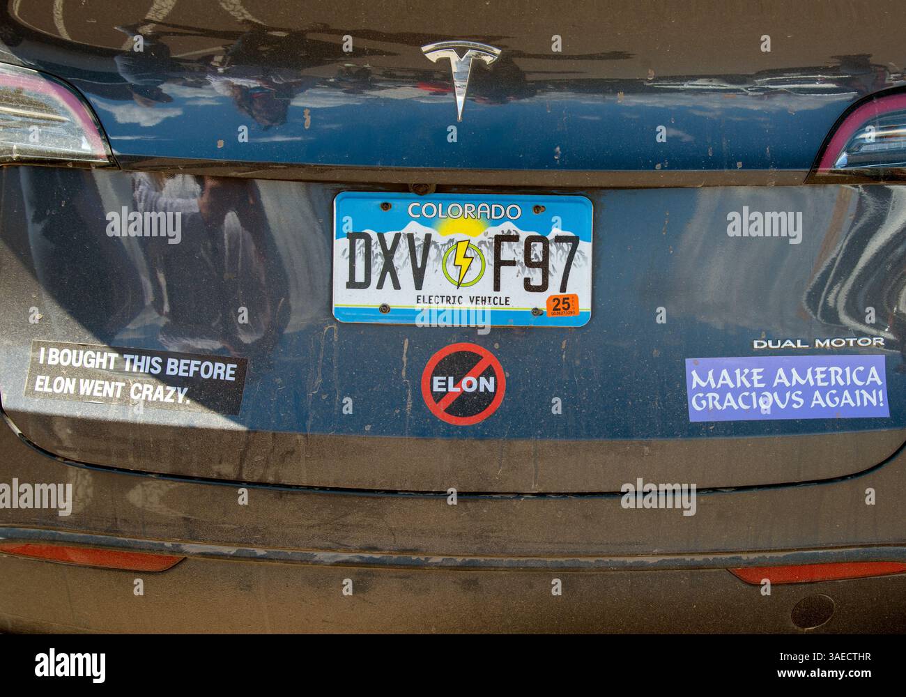A Tesla car with anti-Musk bumper stickers at a "Hands Off " protest ...