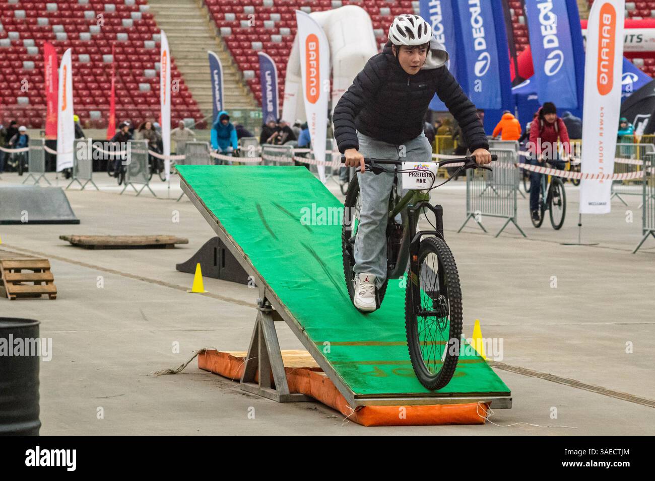 A young cyclist rides over see-saw on the Expo test course On the ...