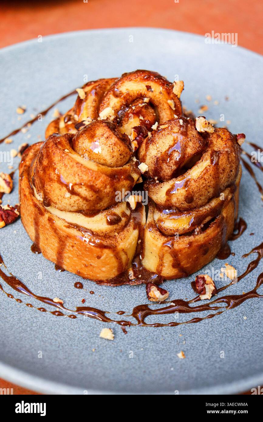delicious cinnamon bun with caramel sauce and sprinkled with chopped ...