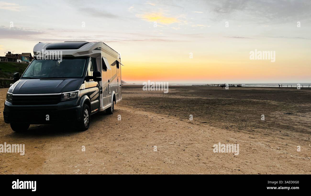 Camper vehicle on beach with beautiful sunset background, modern RV in ...