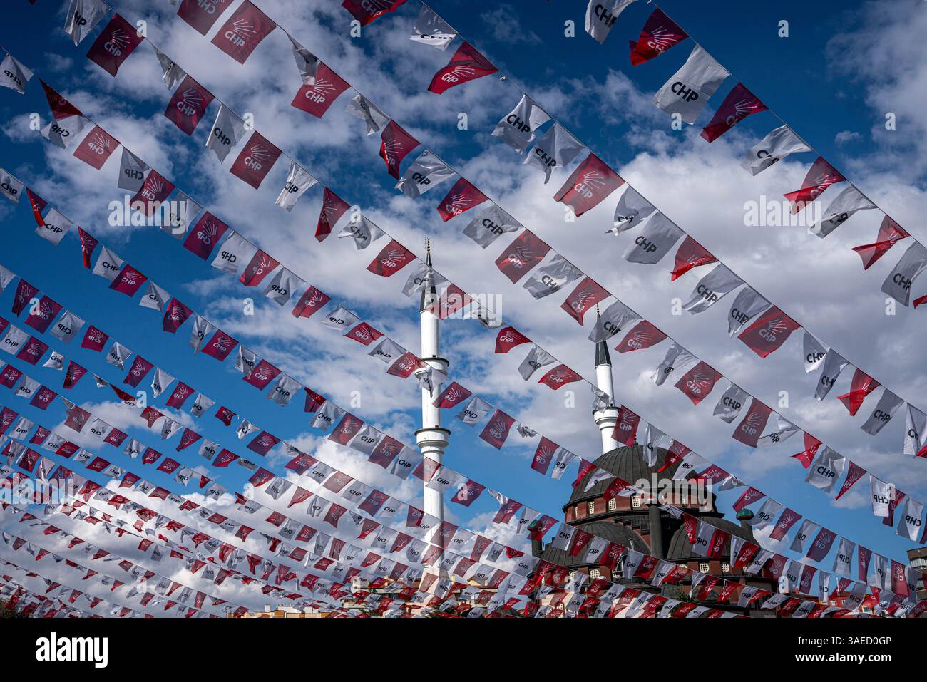 CHP flags seen in the rally area and the mosque minarets behind them ...