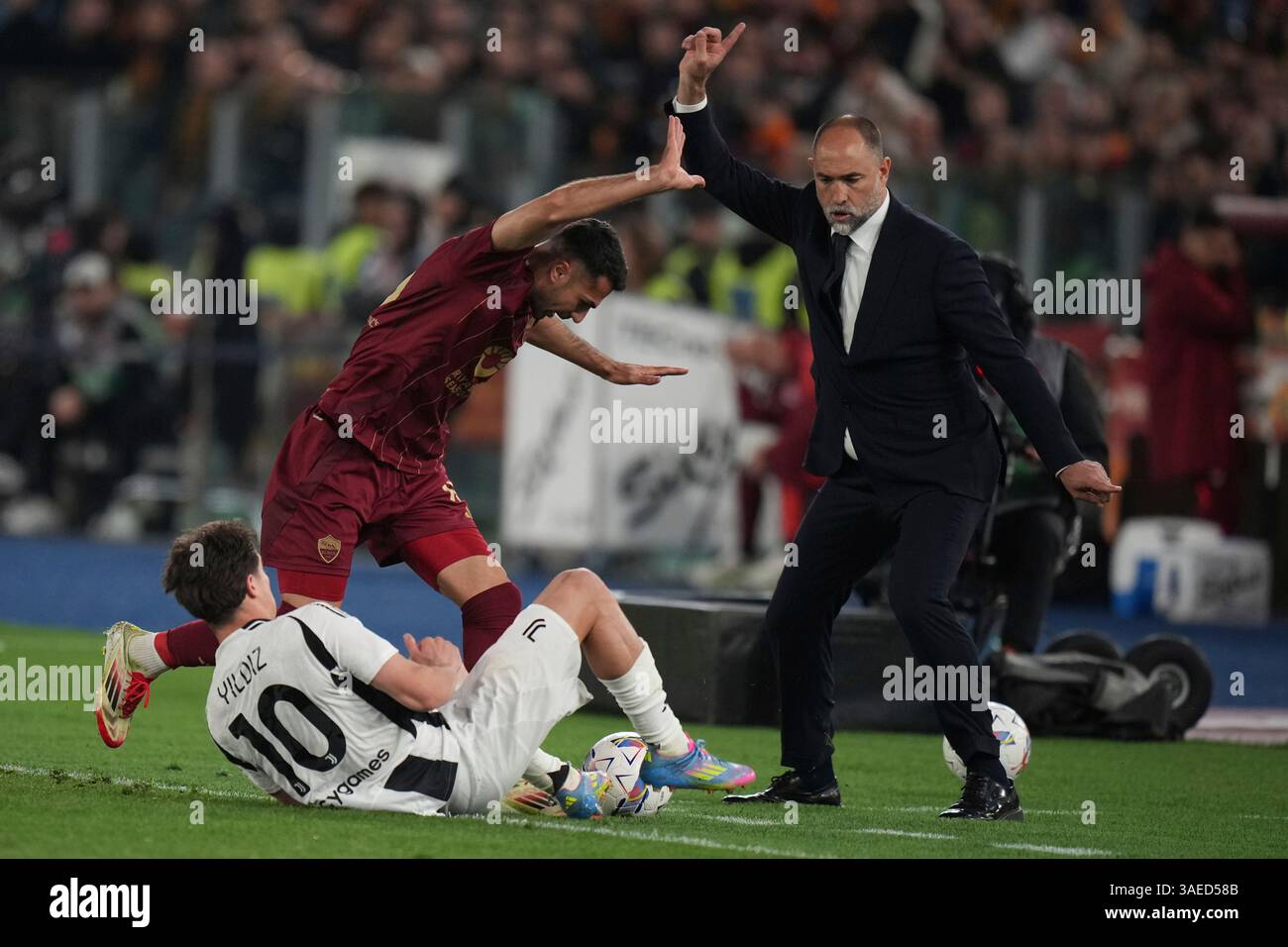 Juventus' Kenan Yildiz tackles Roma's Eldor Shomurodov in front of ...