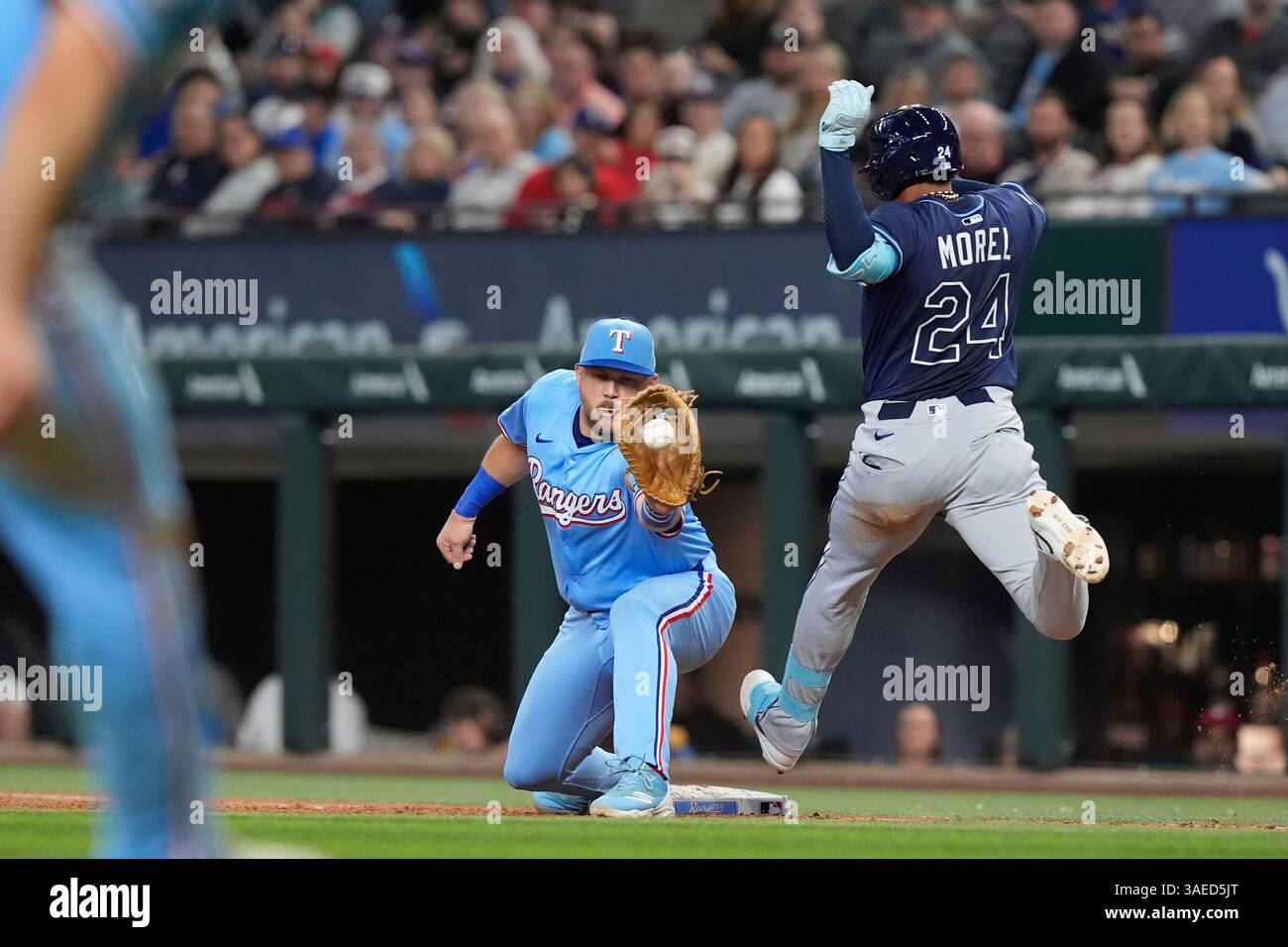 Texas Rangers first baseman Wyatt Langford (36) catches the throw from ...