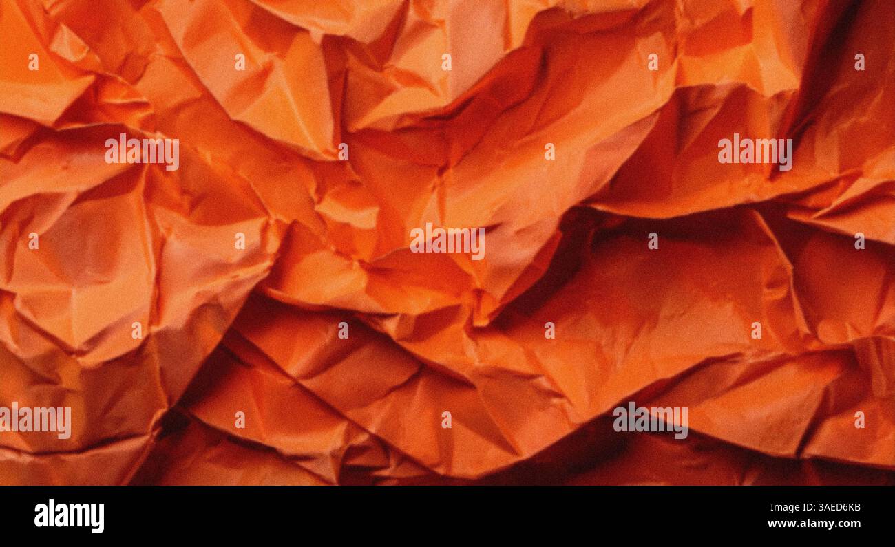 Crumpled orange wrapping paper forms abstract textured background Stock ...