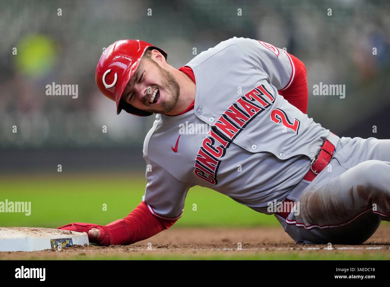 Cincinnati Reds' Gavin Lux reacts after being hit by a pickoff throw at ...