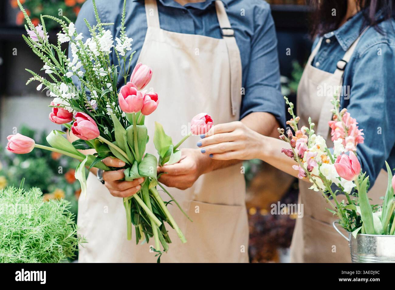 Male and female florists focused on composition in flower shop Stock ...