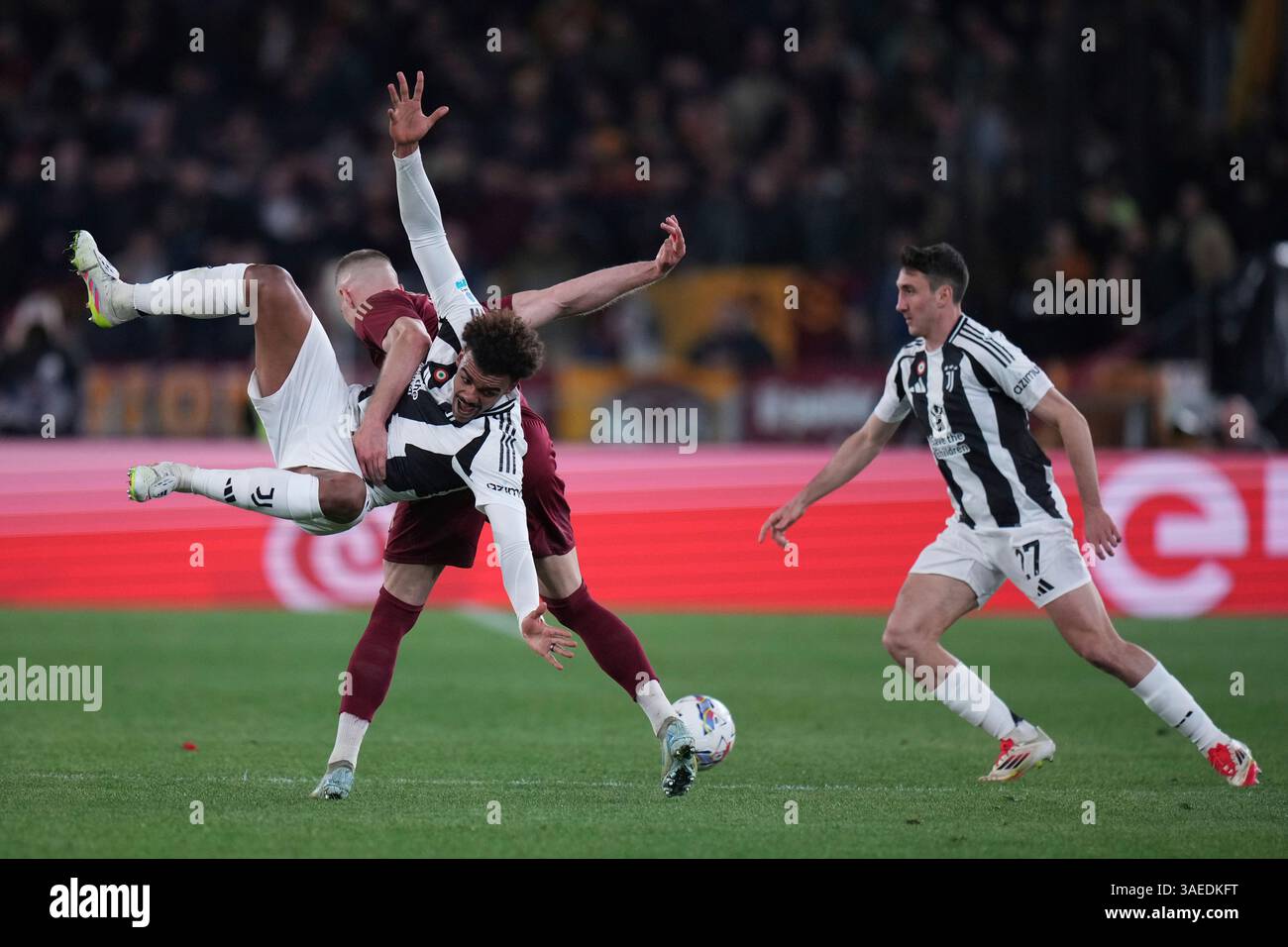 Roma's Artem Dovbyk holds Juventus' Renato Veiga during a Serie A ...