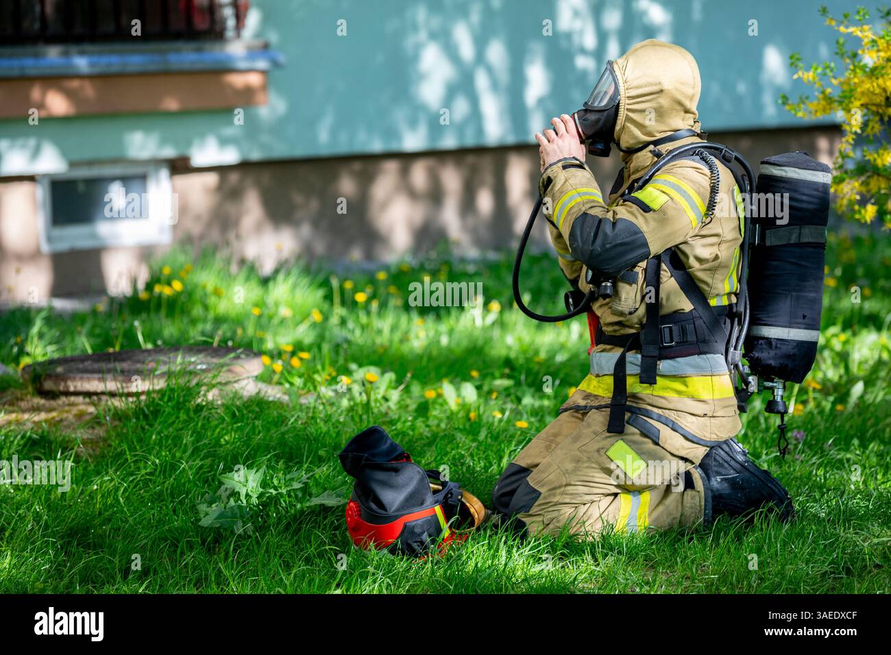 A brave firefighter in protective gear is assessing the environment for ...