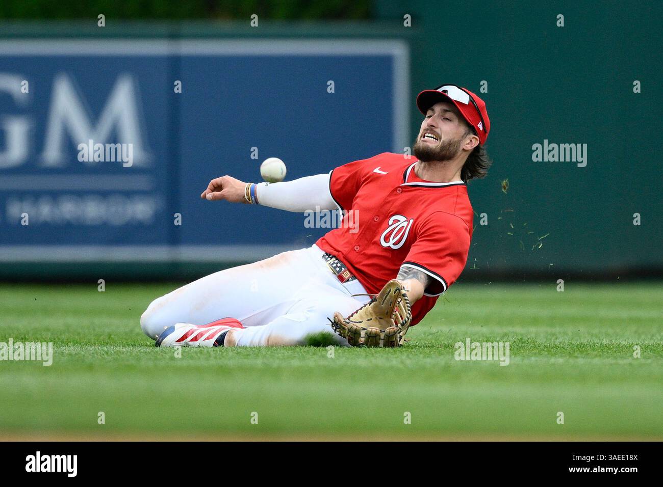 Washington Nationals center fielder Dylan Crews slides for a ball hit ...