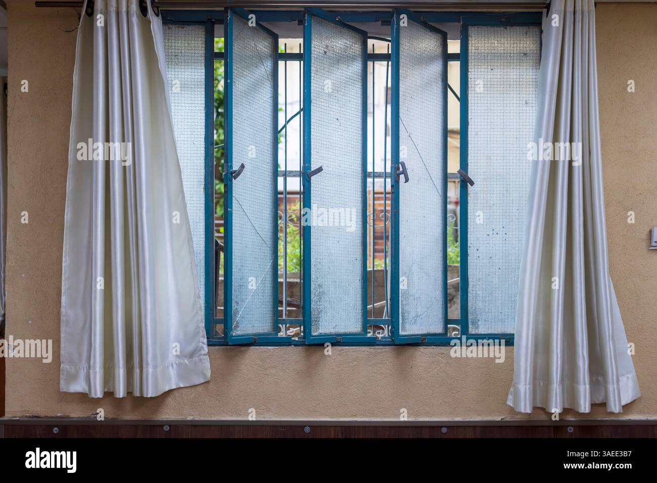 Interior view of a window with partially opened shutters and light ...