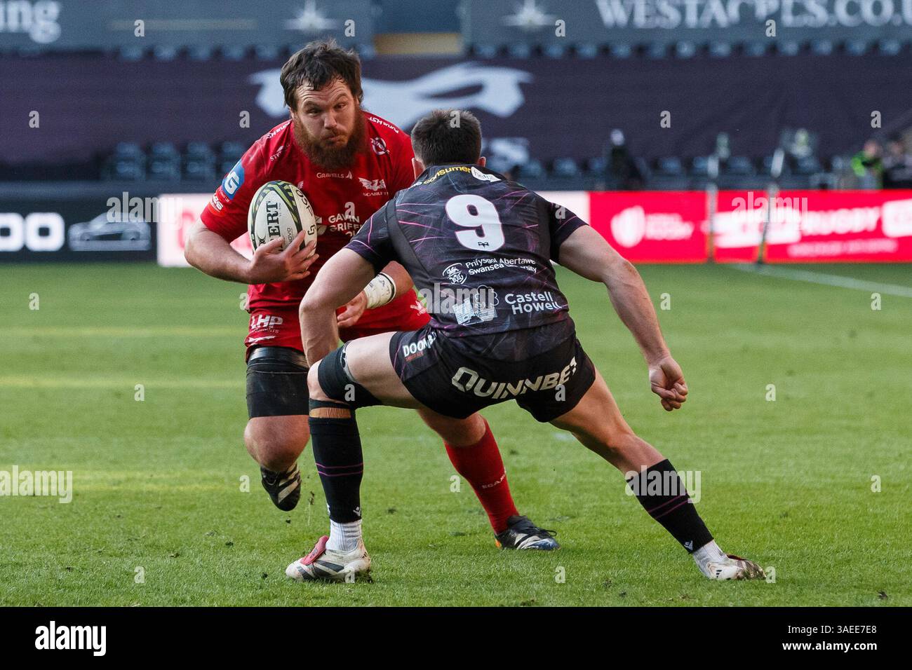 Swansea, UK. 6 April, 2025. Marnus van der Merwe of Scarlets takes on ...