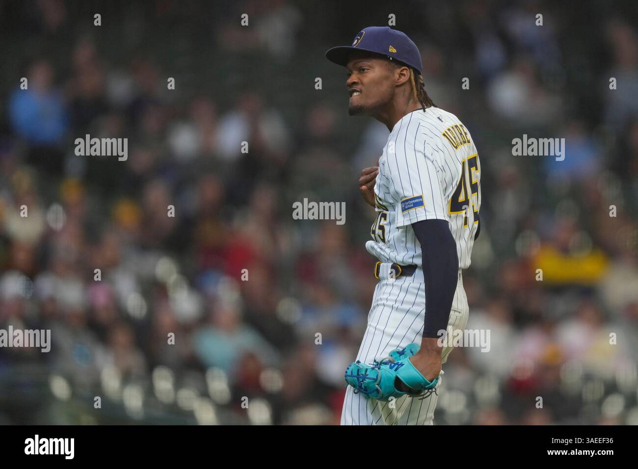 Milwaukee Brewers' Abner Uribe gestures as he walks to the dugout ...