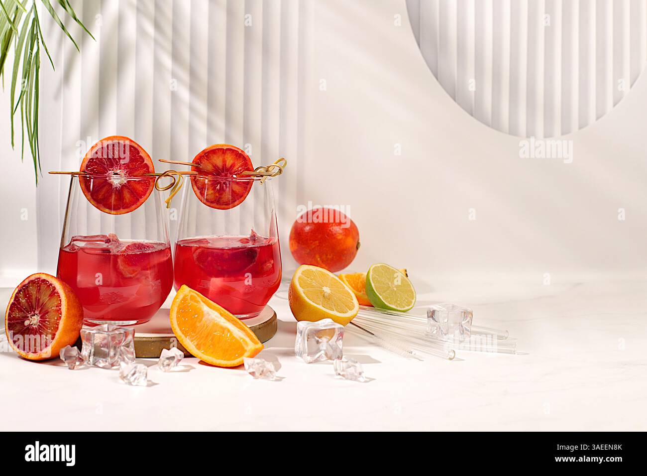 Royal cocktail of blood orange, ice cubes, rum and tequila. Summer ...