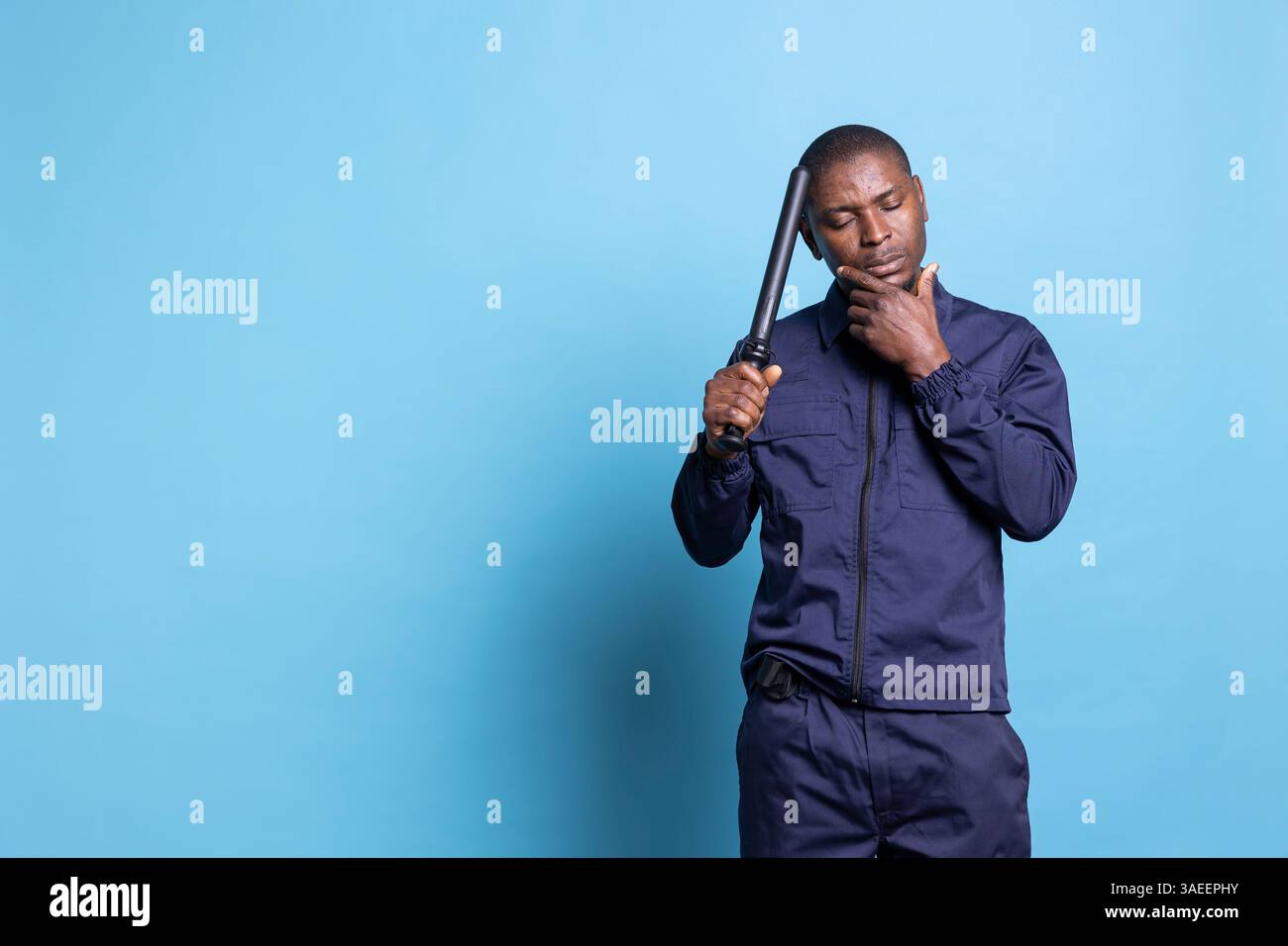 Security agent presenting a police baton and his clenched fist ...