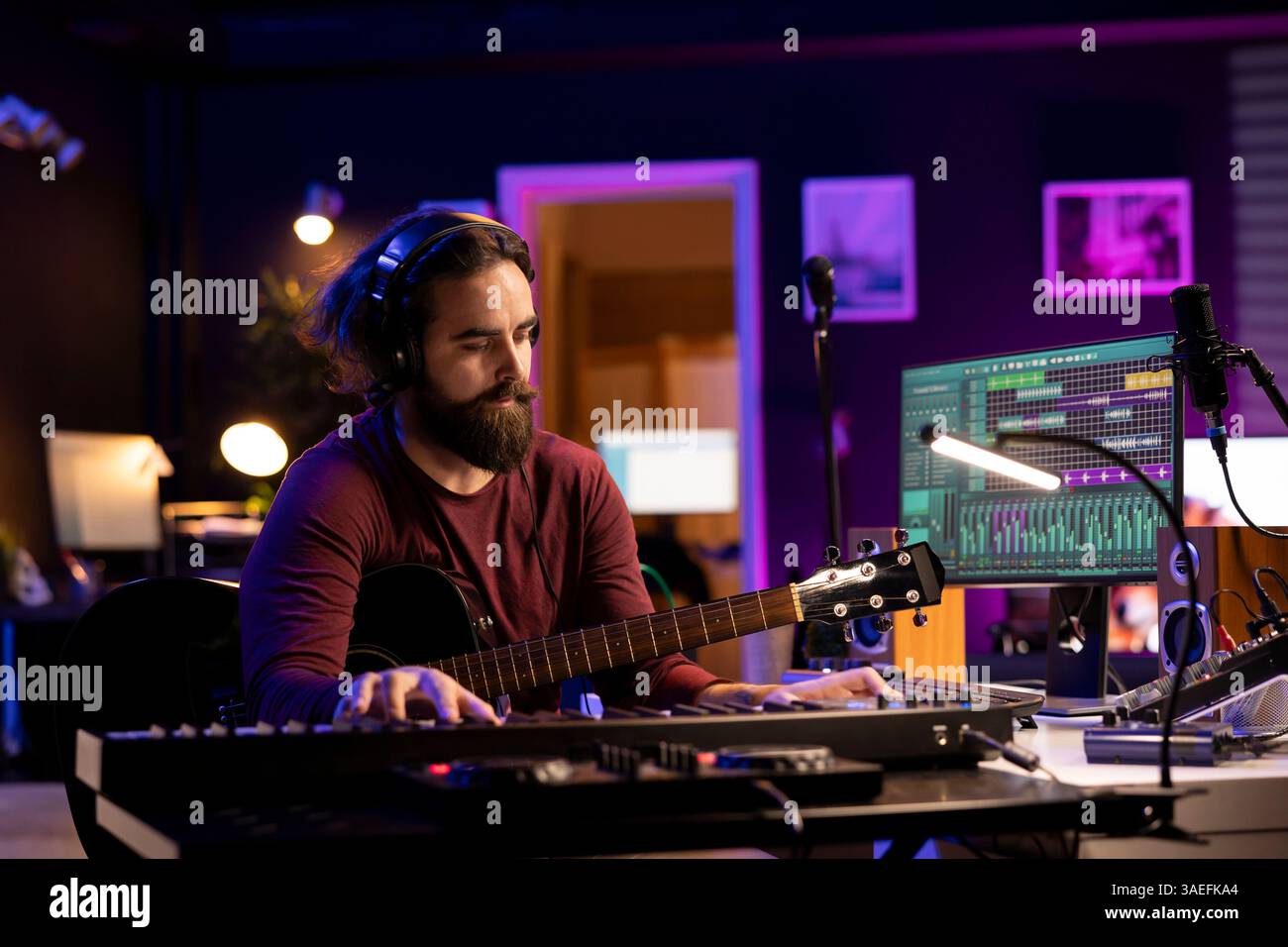 Skilled artist musician composing a song and playing his guitar ...