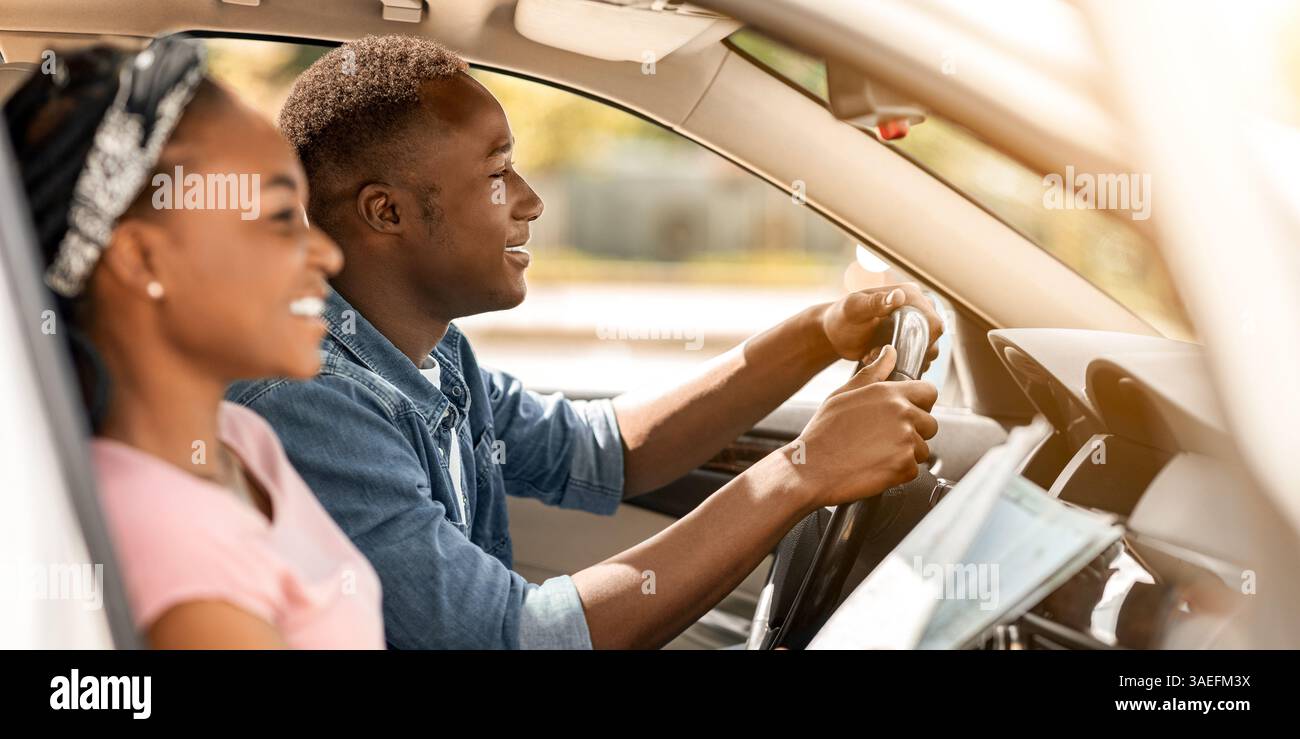 Cheerful black lady helping her driving boyfriend, checking map Stock ...
