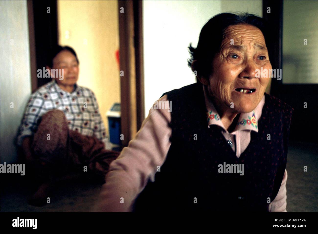 Apr 24, 2001; Hapchon, South Korea; KIM HE SUN, 80, right, rests after ...