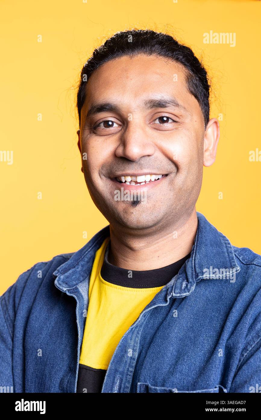Portrait of jolly indian man smiling and posing with arms crossed ...