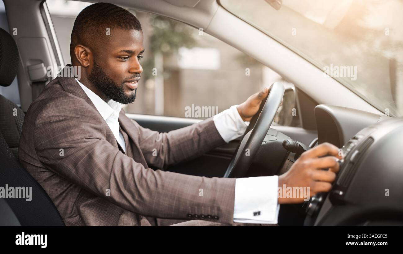 African american businessman turning on music in car before moving ...