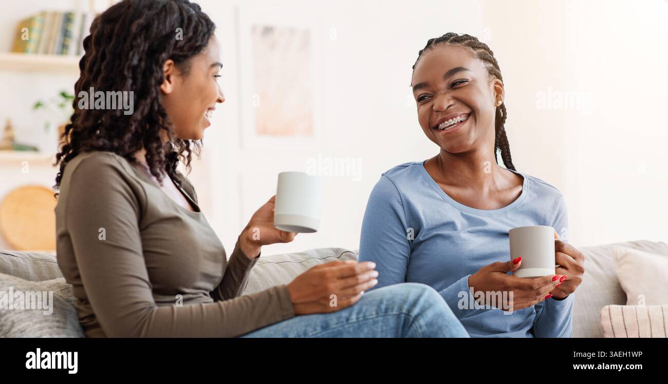 Two pretty black ladies drinking tea at home Stock Photo - Alamy
