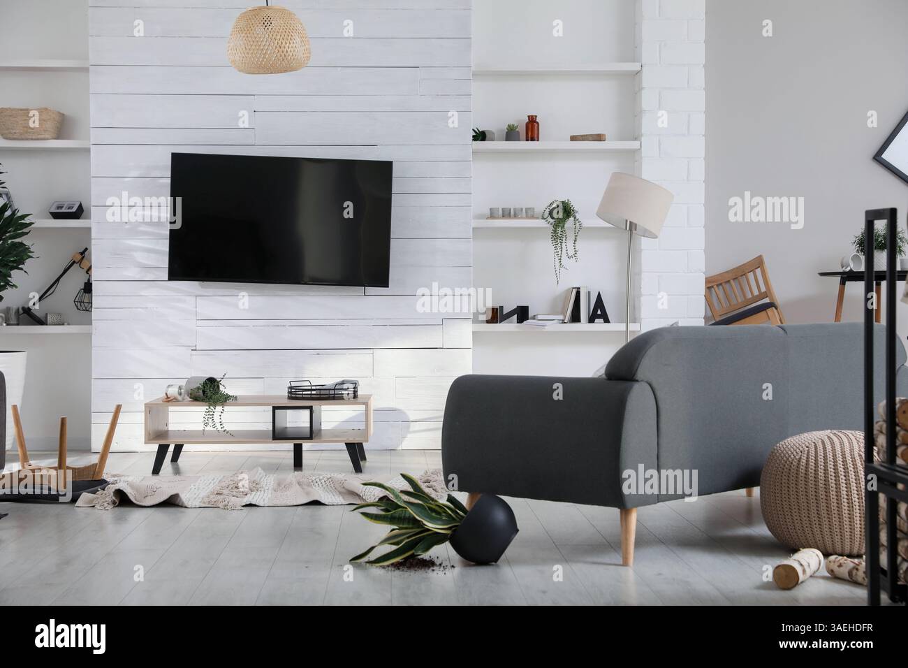 Chaotic living room interior after strong earthquake Stock Photo - Alamy